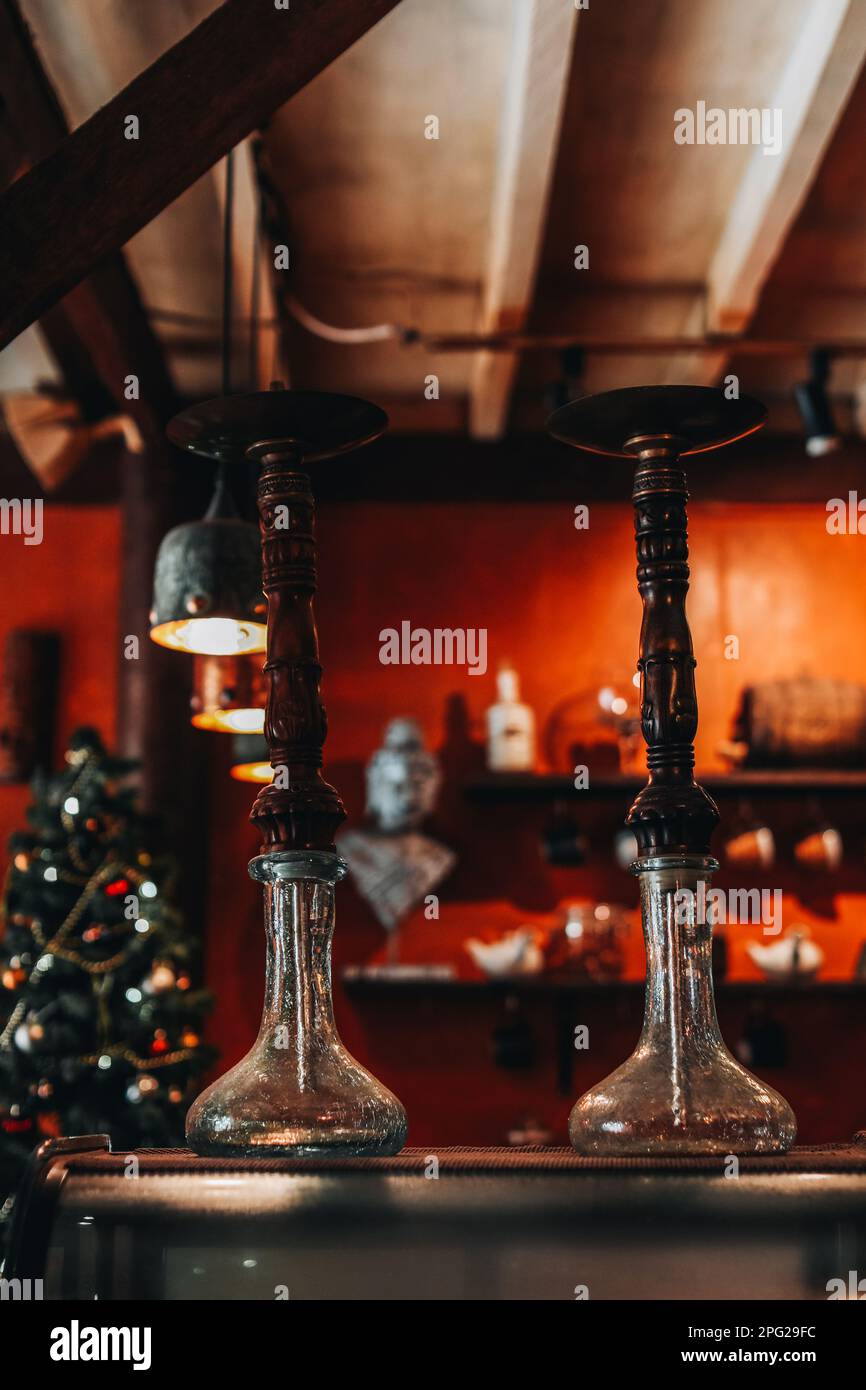 Minimalistic hookahs with a glass flask standing on a table. Vertical ...