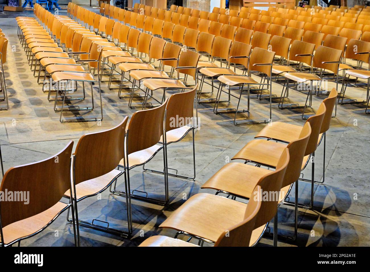 Rows of empty wooden chairs set at an angle in St Nicholas Cathedral ...