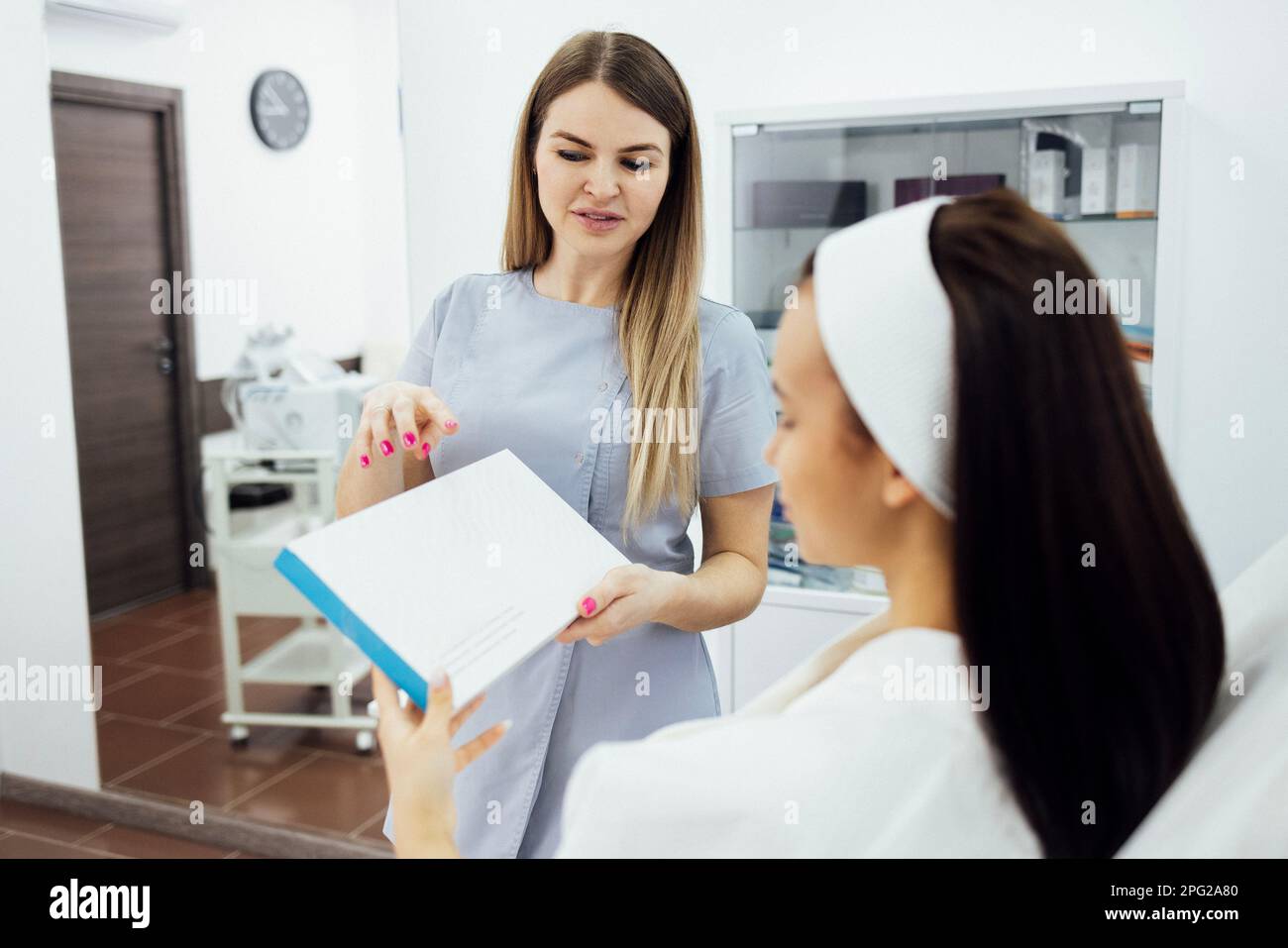 Pretty caucasian beautician communicates with her female client. Beauty ...