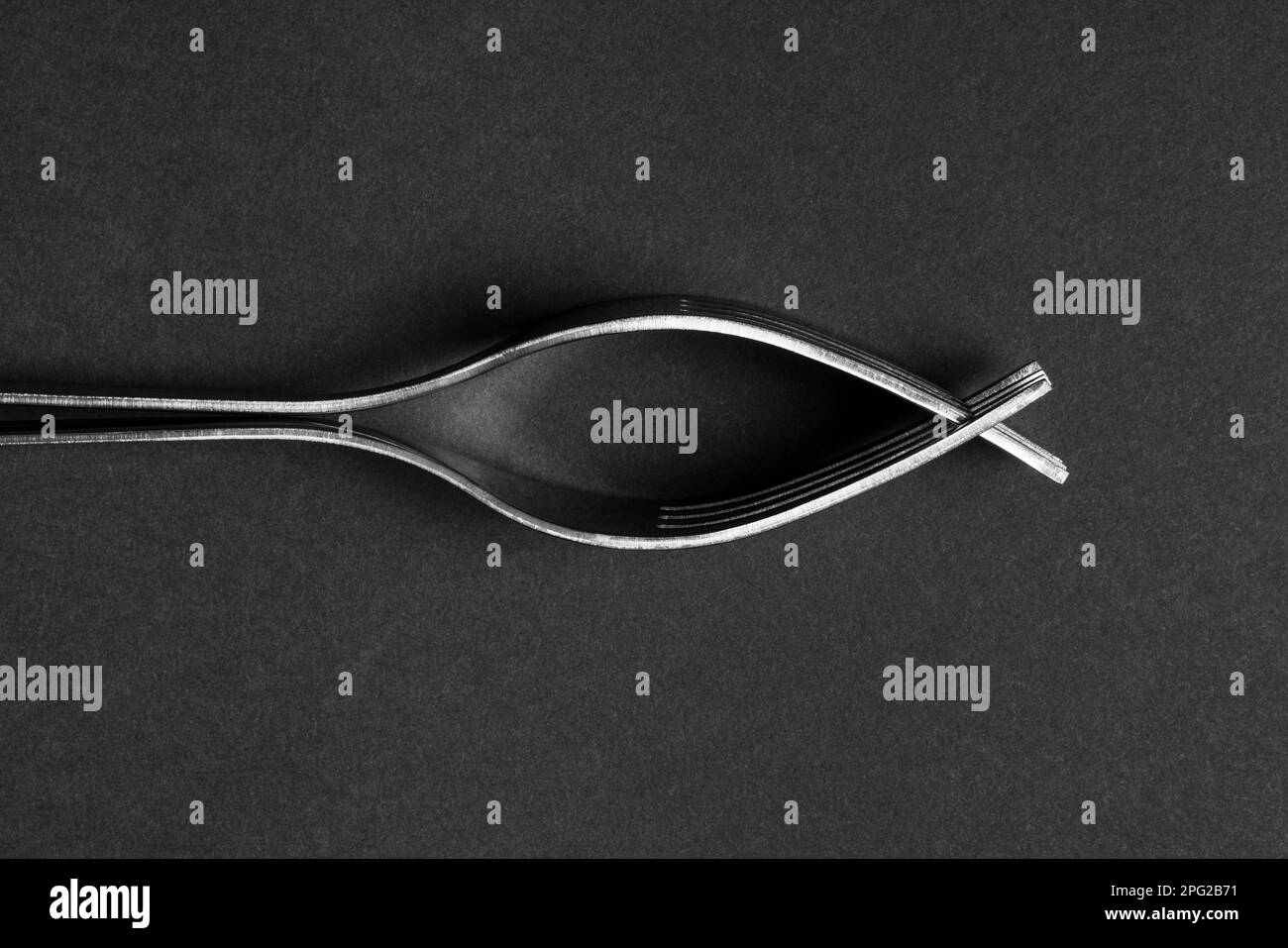 Two kitchen forks together on their side on a dark background Stock ...