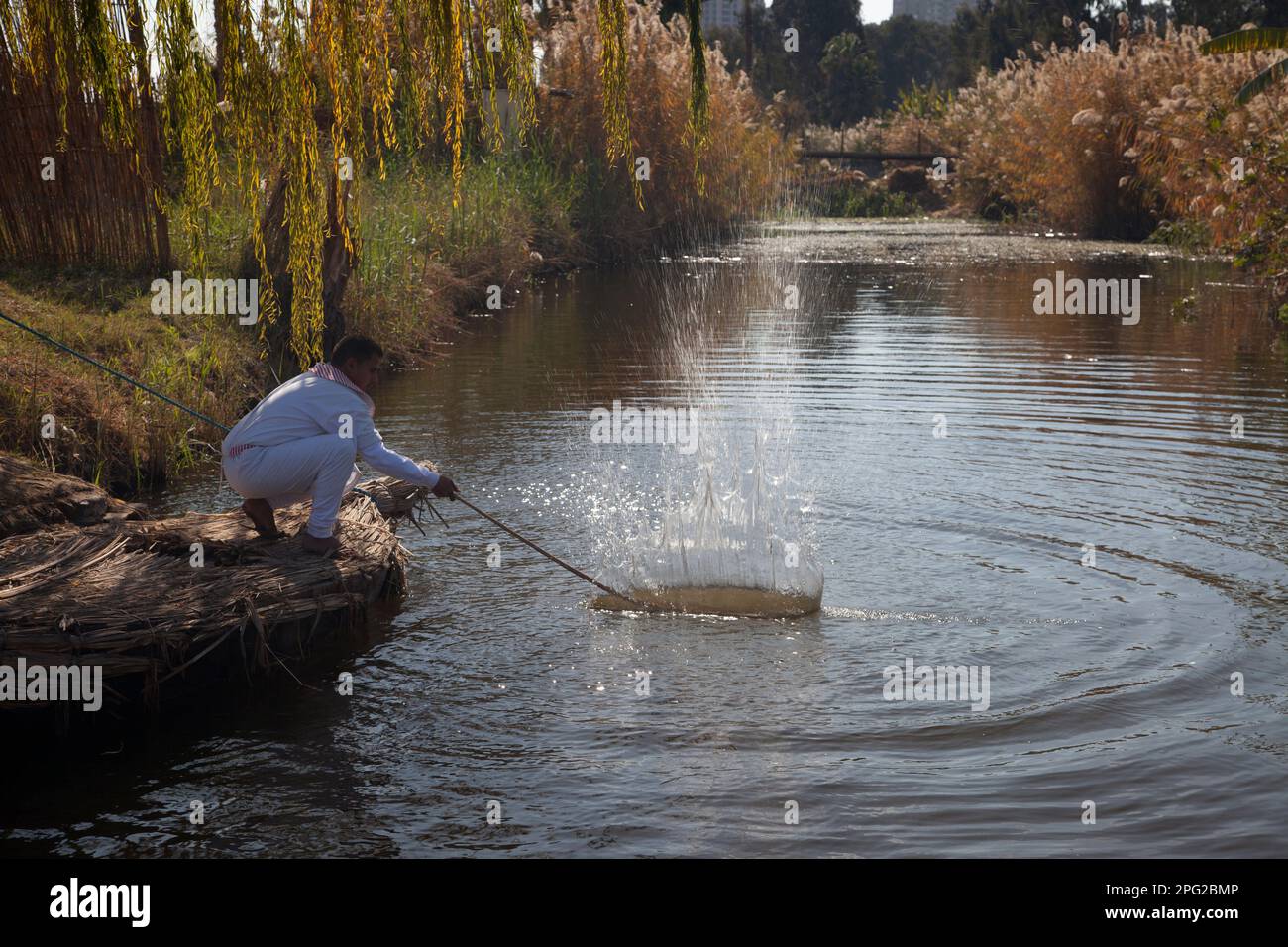 Egypt, Cairo, the Pharaonic Village on the Nile, man fishing with ...