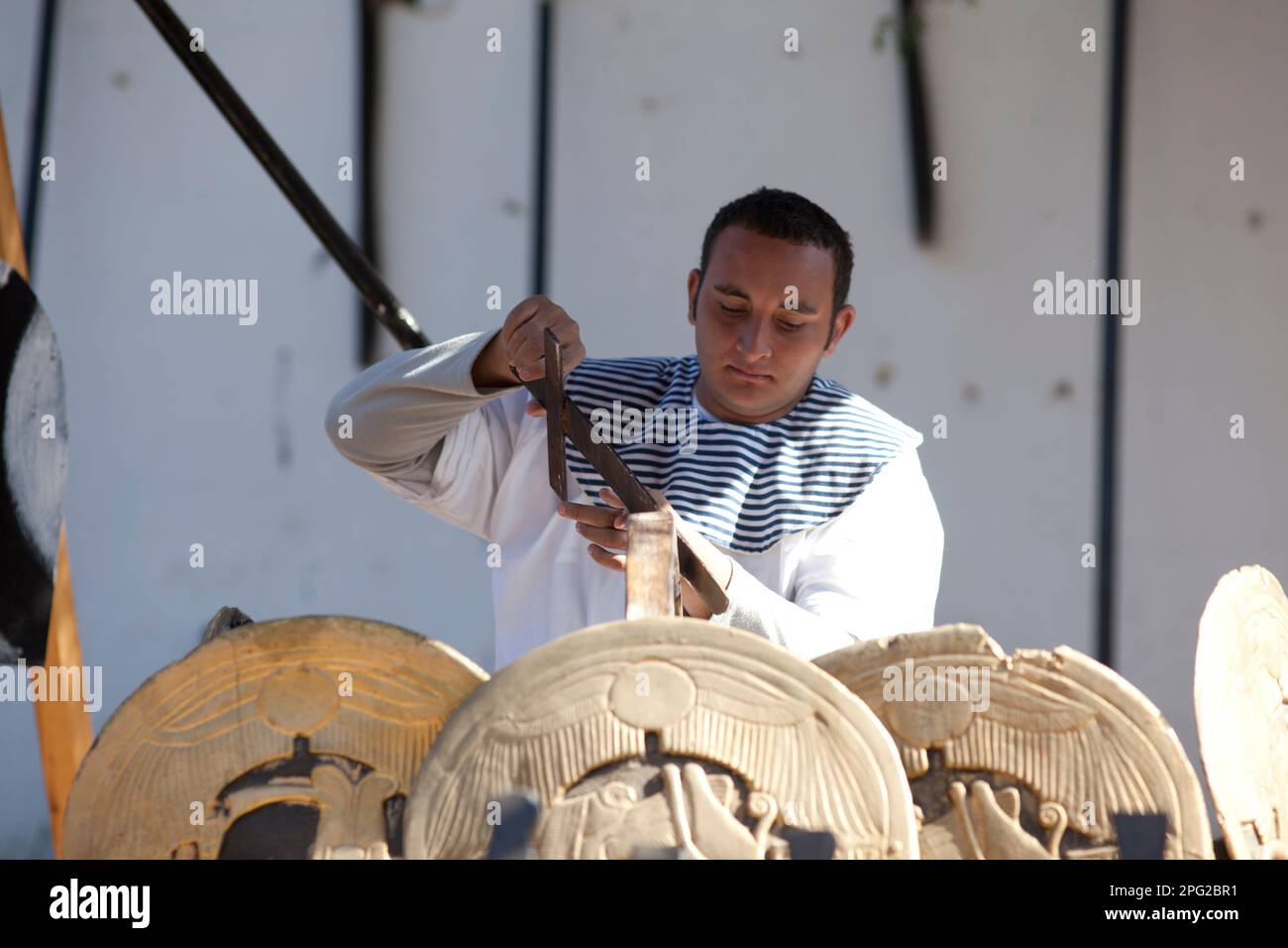 Egypt, Cairo, the Pharaonic Village on the Nile, man sharpening sword ...