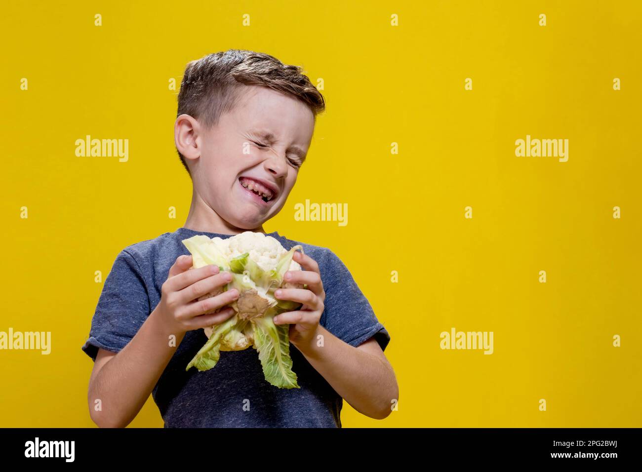 A charming little boy refusing to eat cauliflower. Healthy food Stock ...