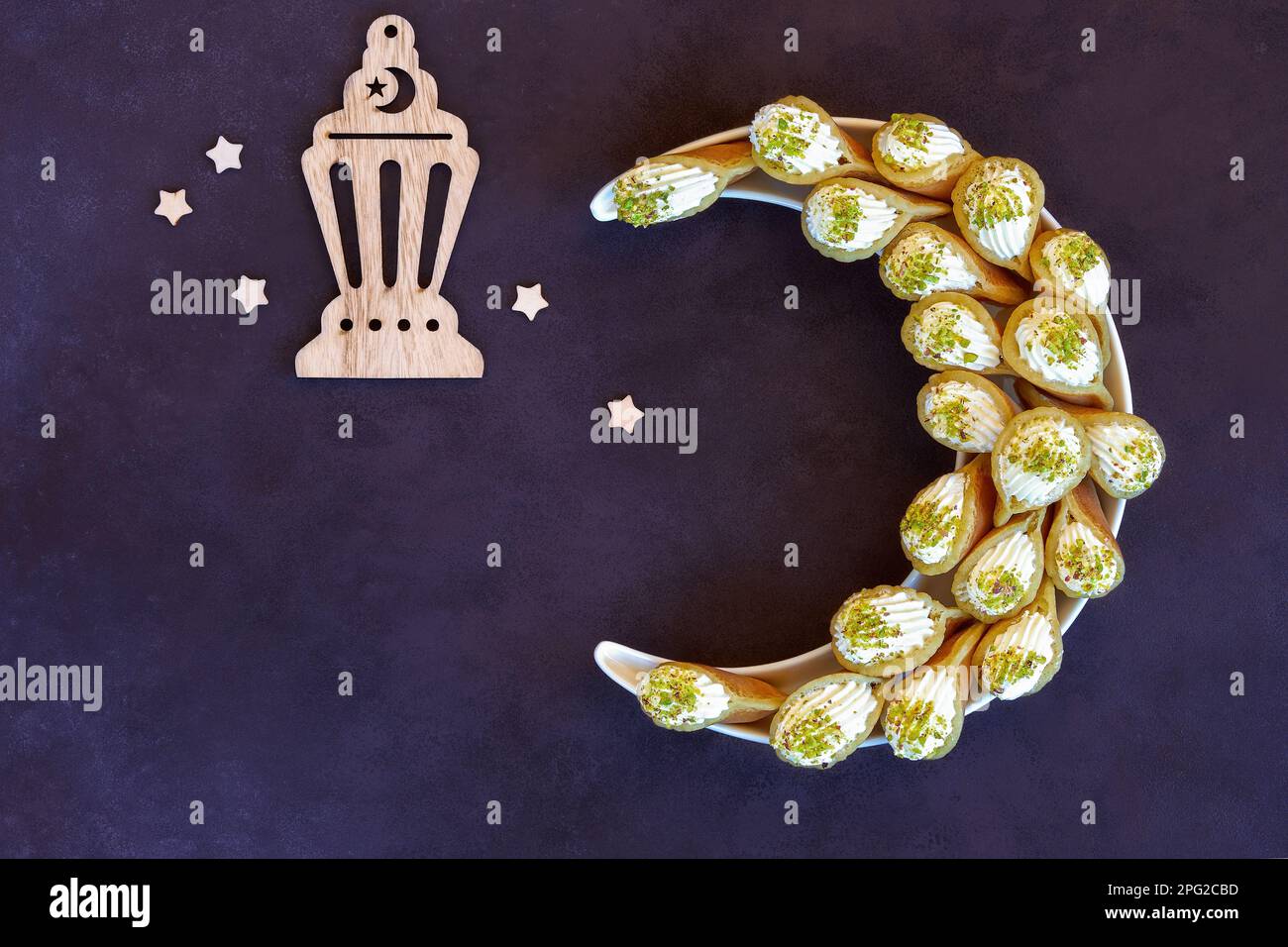 Ramadan kareem with qatayef arranged in shape of crescent moon ...