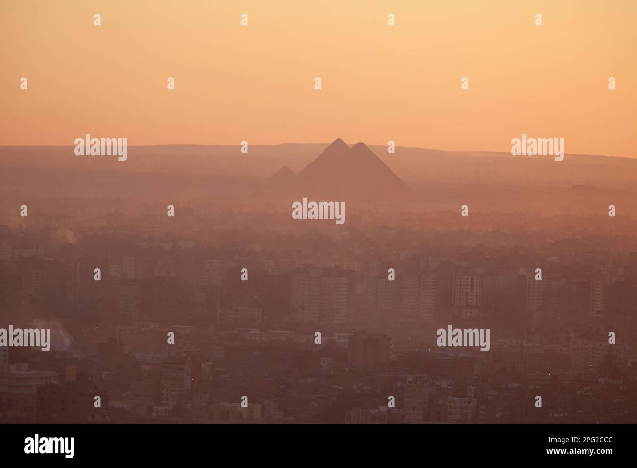Egypt, Cairo, the Pyramids of Giza in the distance and sunset over ...