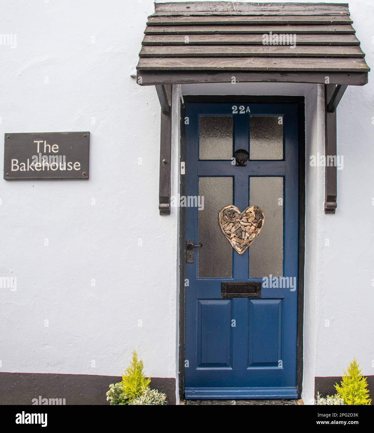 A blue painted door with glass panels, wooden porch and a heart ...
