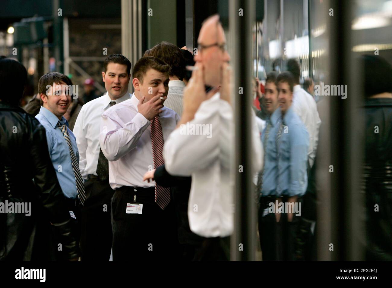 Workers taking cigarette break outside the Headquarters of Bear Sterns ...