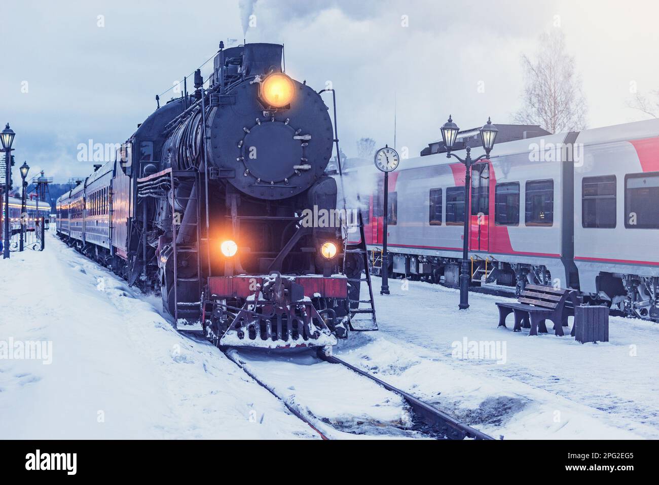 Retro steam train arrives at winter morning time Stock Photo - Alamy