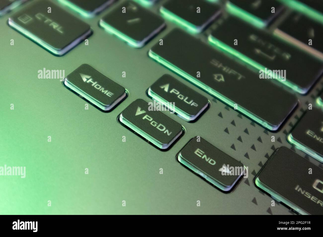 Laptop arrow buttons in green light with blurred background. Gaming ...