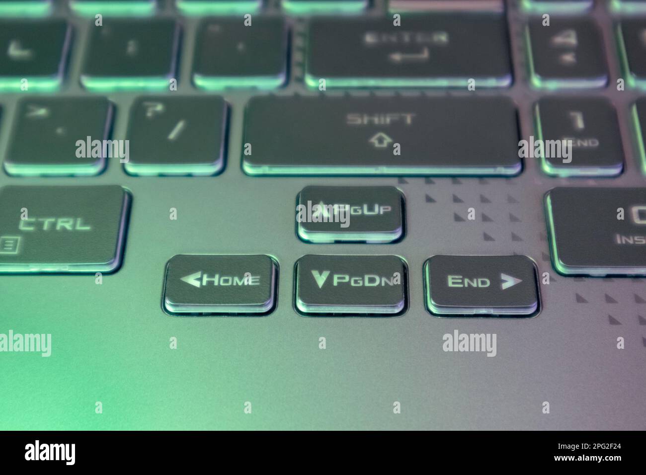 Laptop arrow keys with green light and blurred background. Gaming ...