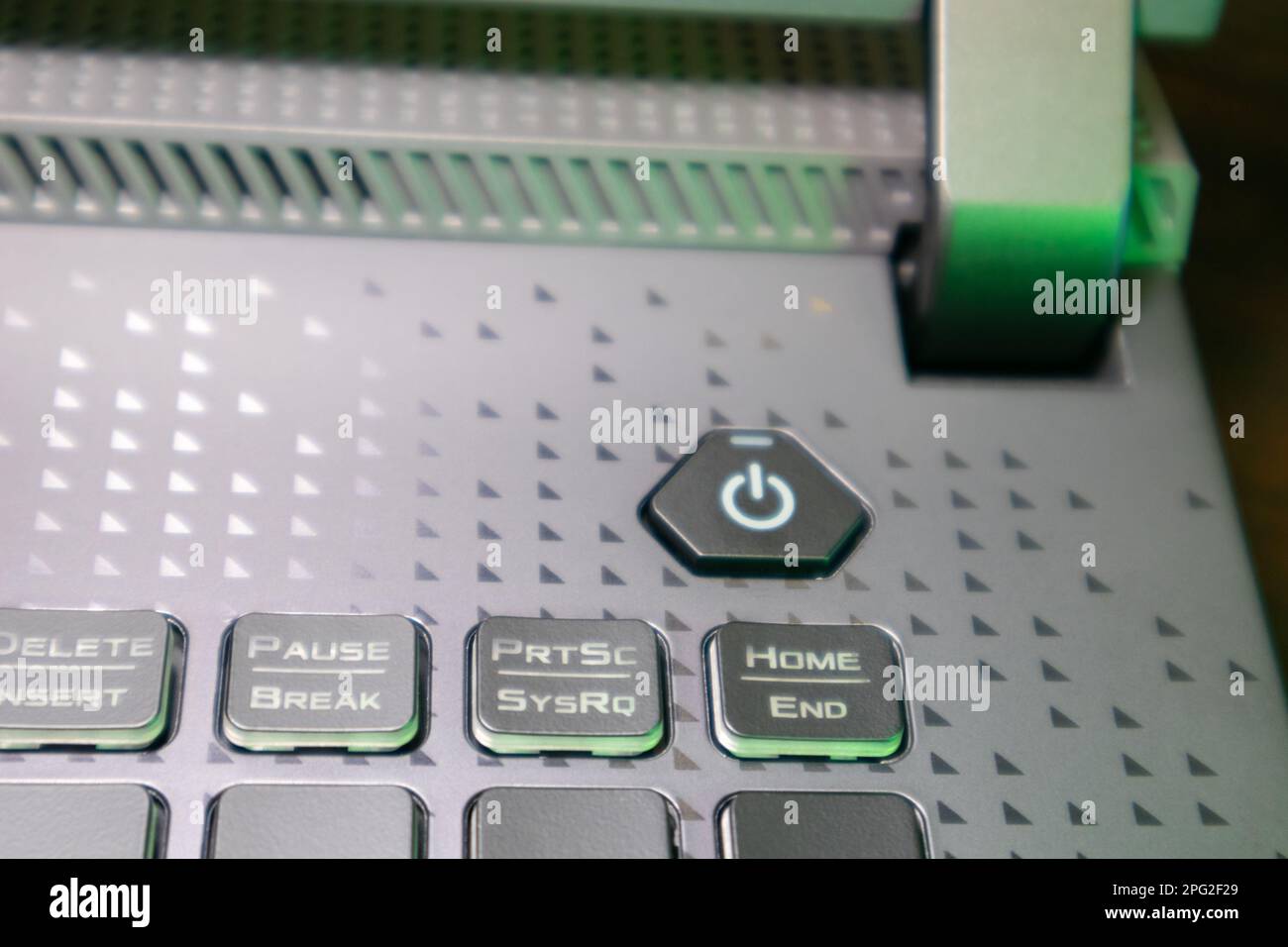 Laptop turn on and off power button with green light. Gaming powerful ...