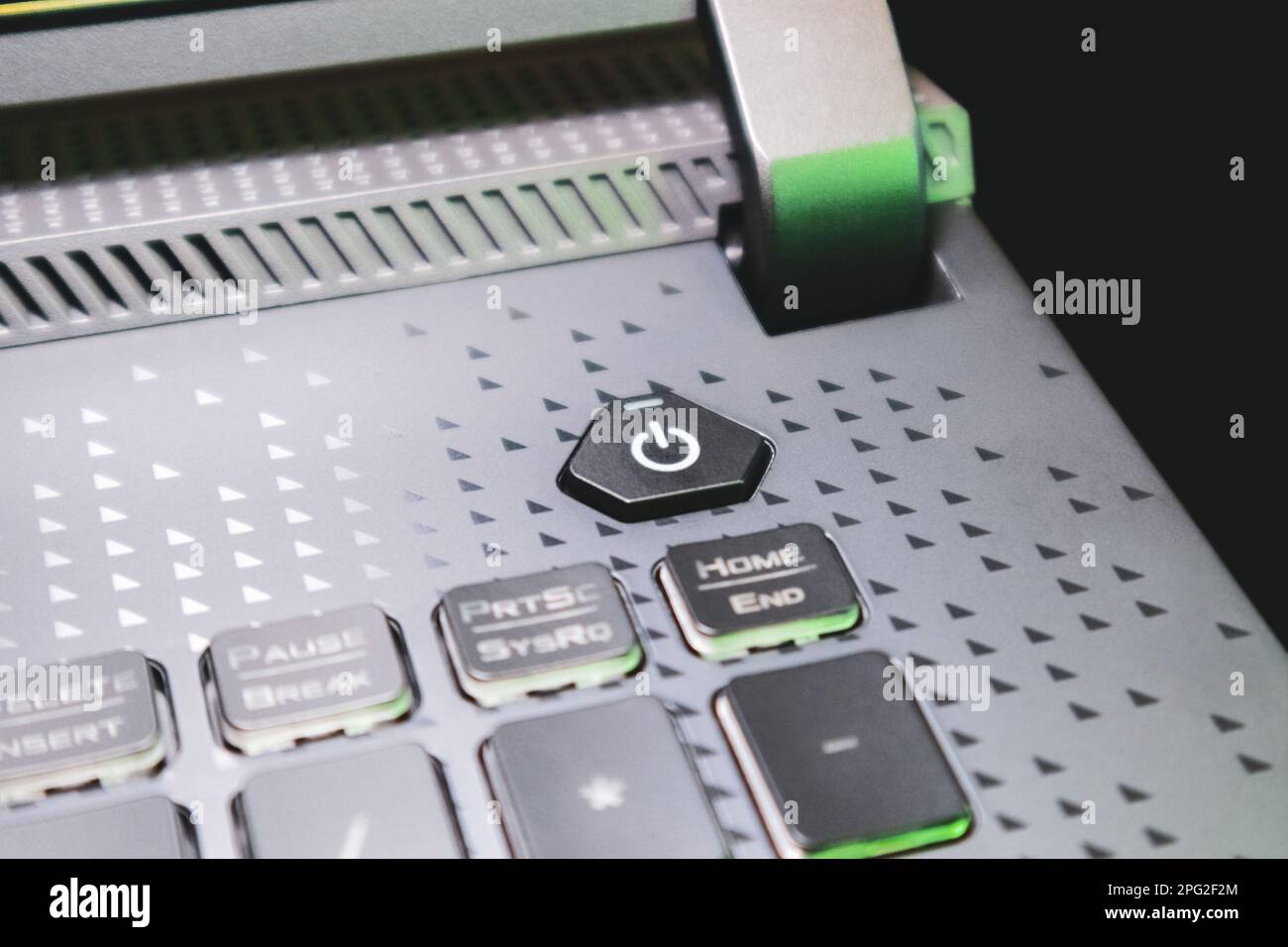 Laptop turn on power key with green light. Gaming powerful grey ...