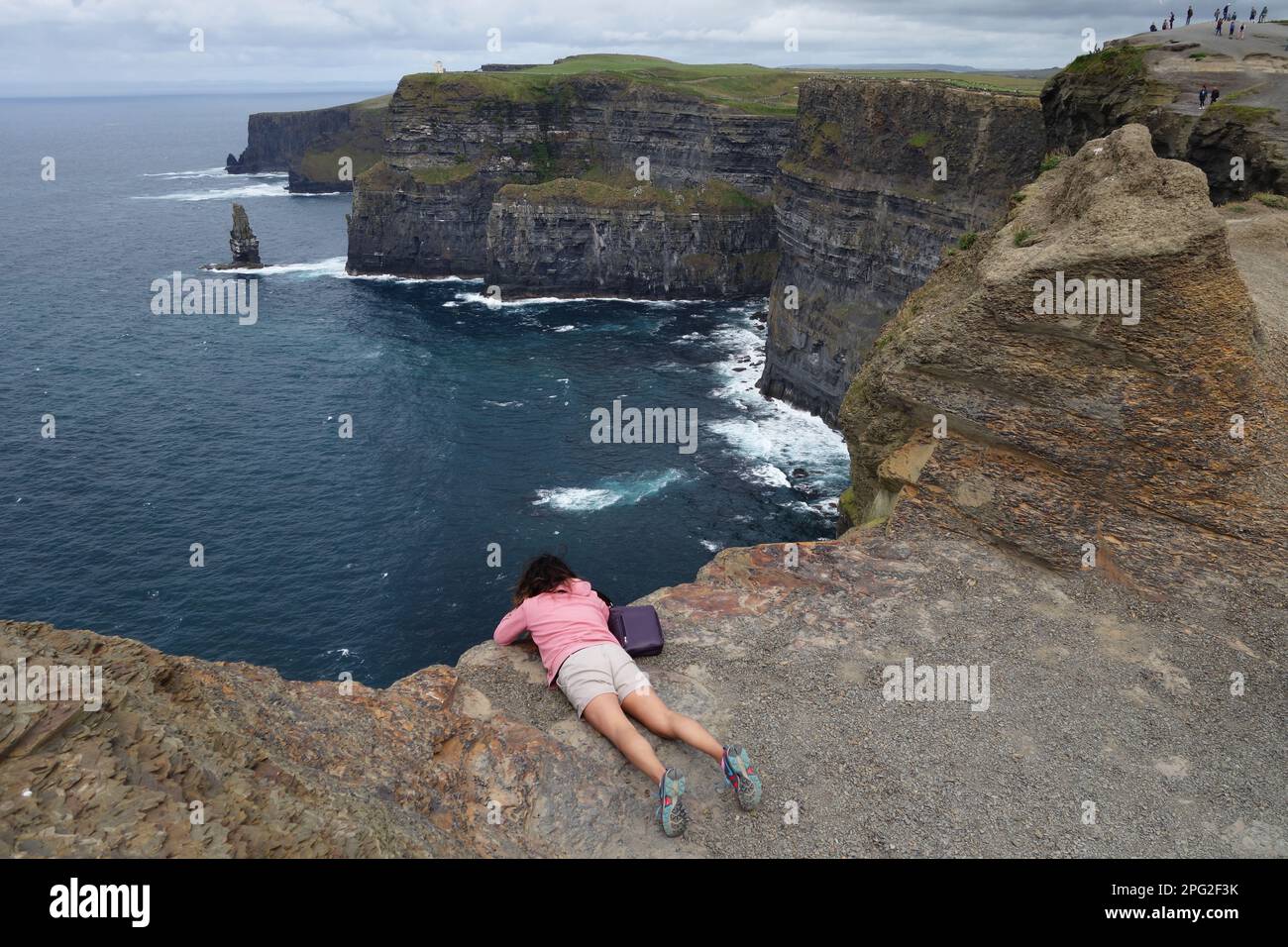 Woman lying down cliff hi-res stock photography and images - Alamy