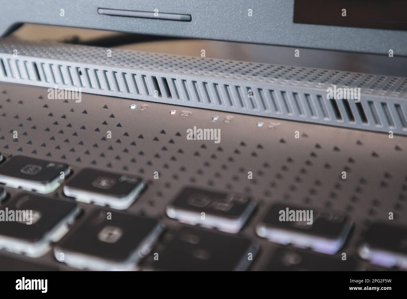 Laptop light indicators close-up . Gaming powerful grey notebook design ...