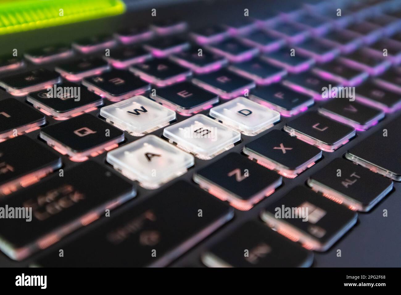Highlighted gaming keys with pink purple gradient light and blurred background. Powerful dark ...