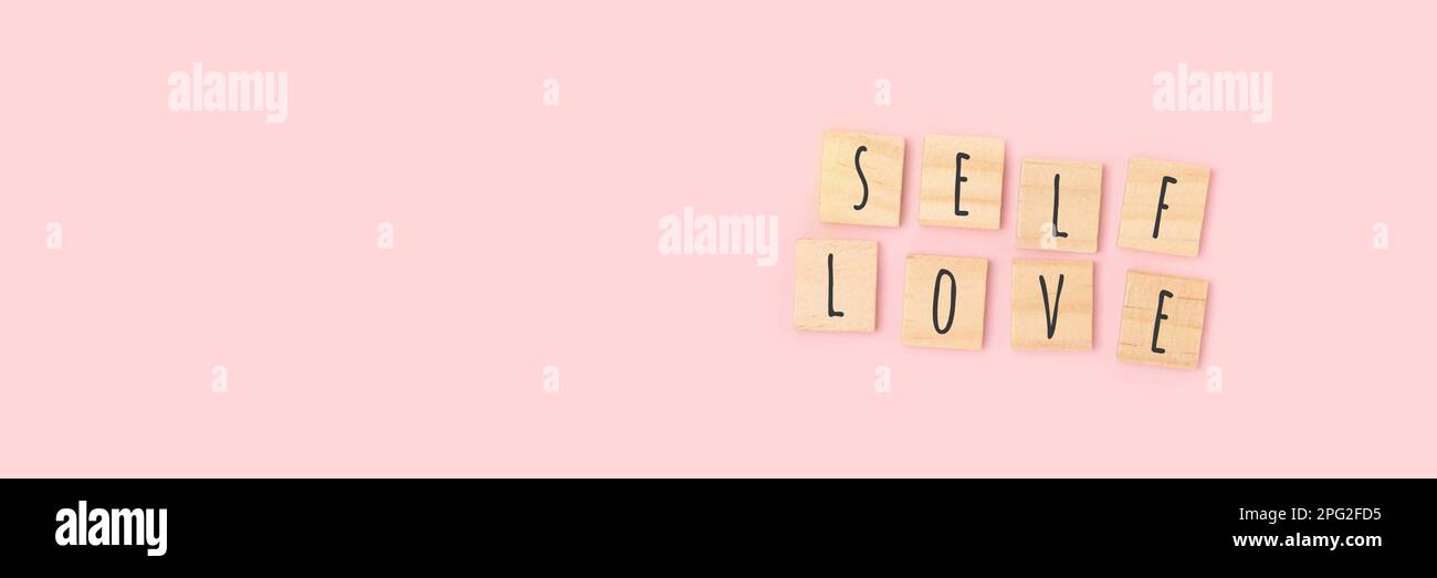 Self love. Banner with quote made of wooden blocks with letters on a ...