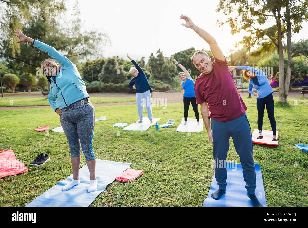 Multiracial senior people doing stretching workout exercises outdoor ...