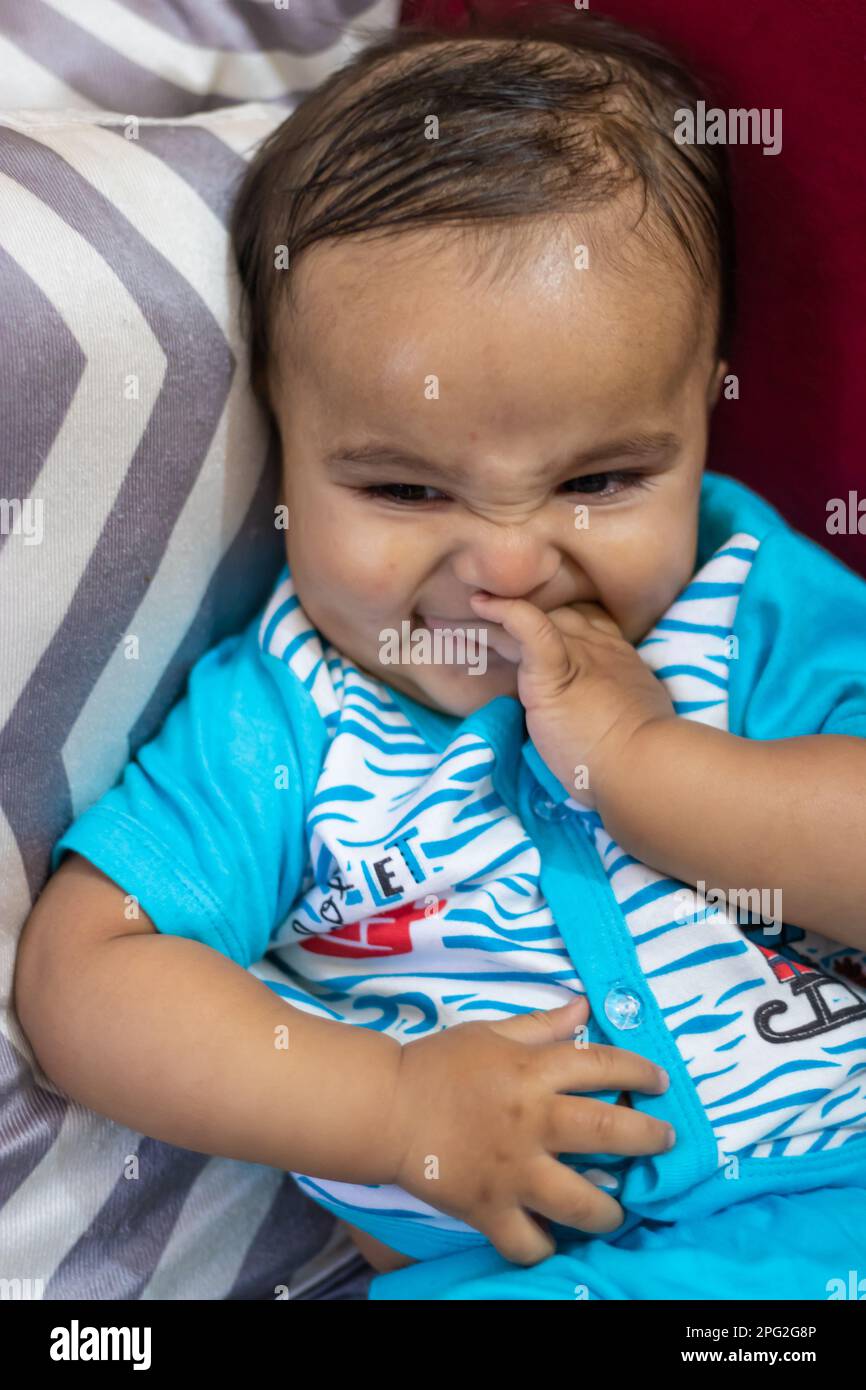 cute infant facial expressing from top angle indoor shot Stock Photo ...