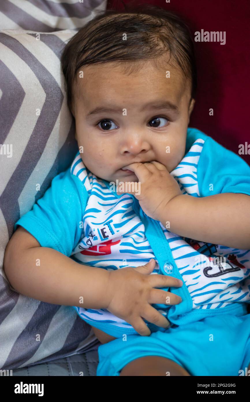 cute infant facial expressing from top angle indoor shot Stock Photo ...