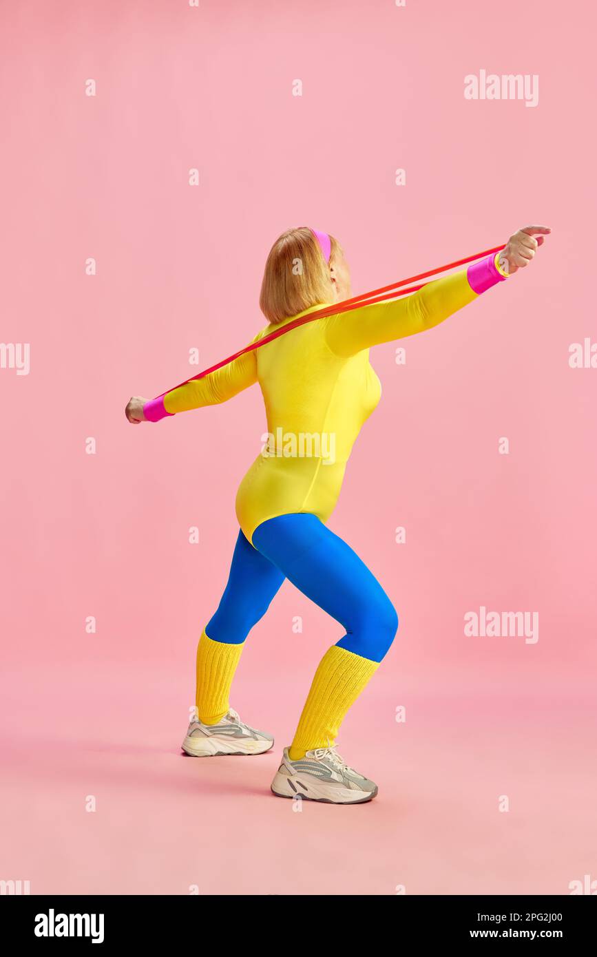 Side view image of elderly sportive woman woman in colorful sportswear ...