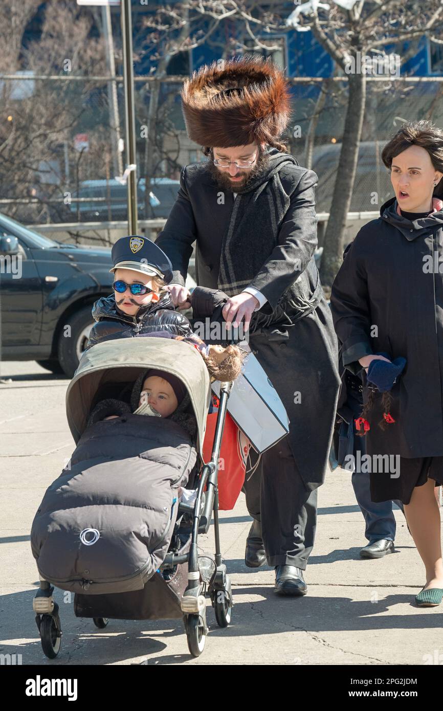 An orthodox Jewish family celebrates Purim, the father by wearing his ...