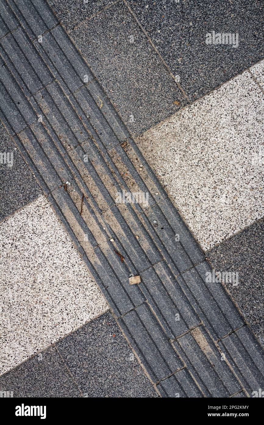 Textured walkway for blind people. Black tactile paving for the ...