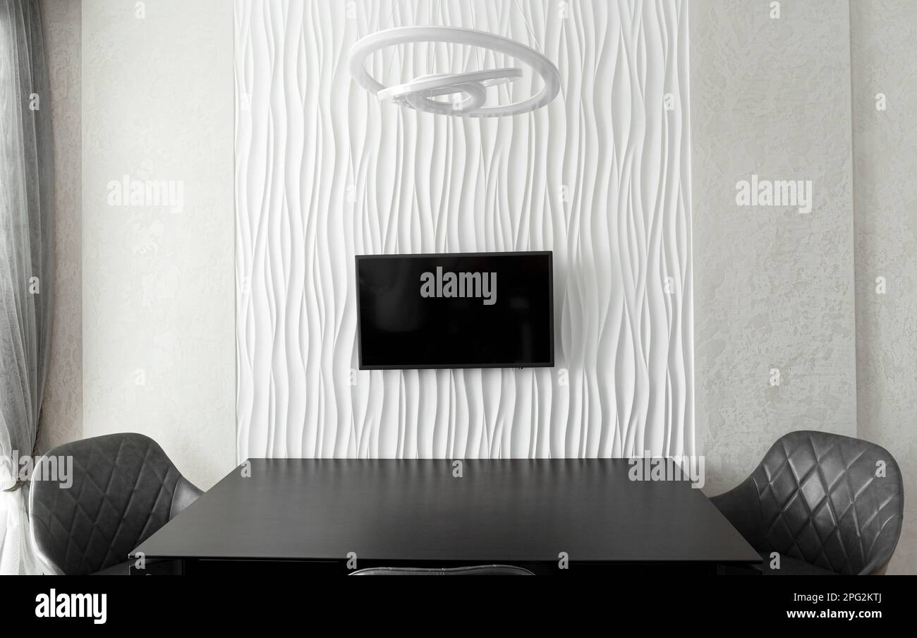 Minimalist interior. A large glass table with chairs against a ...