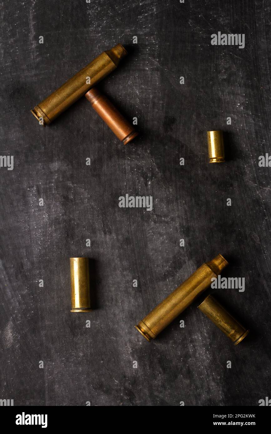 Empty bullet cartridges lying on the black background Stock Photo - Alamy