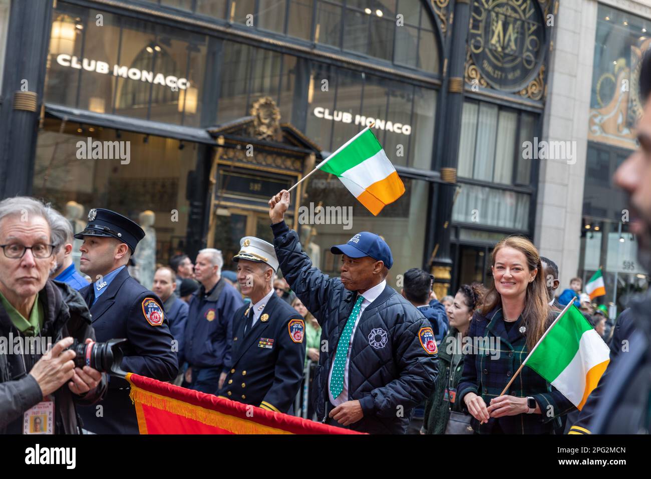 A diverse group of people is gathered together in the city, proudly ...