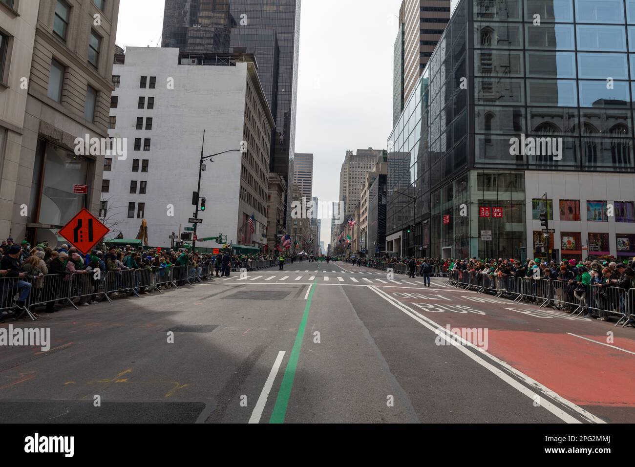 A picturesque road is seen with people standing in orderly lines on ...