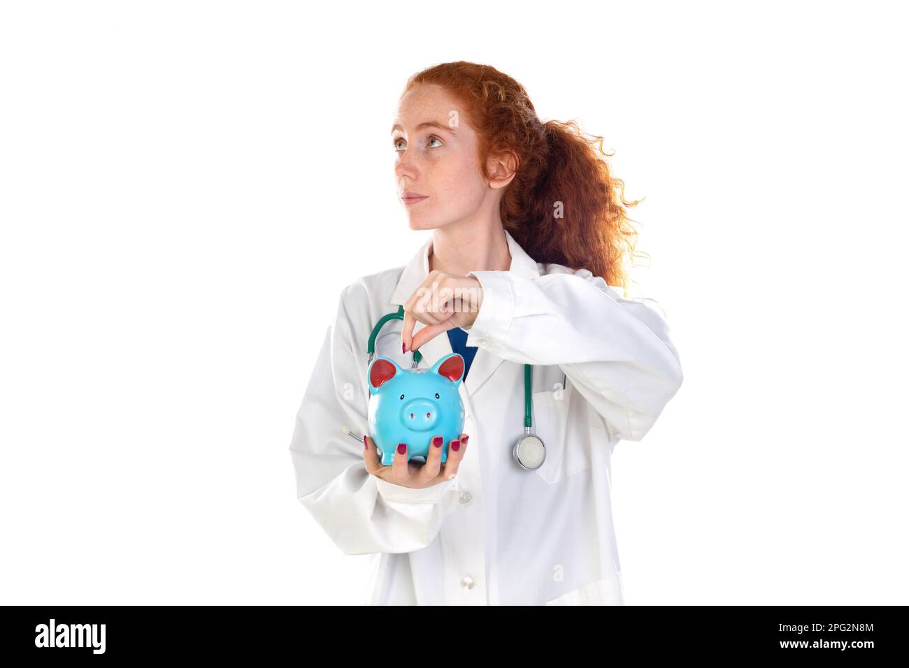 Cute redhead doctor in lab coat saving money isolated on a white ...
