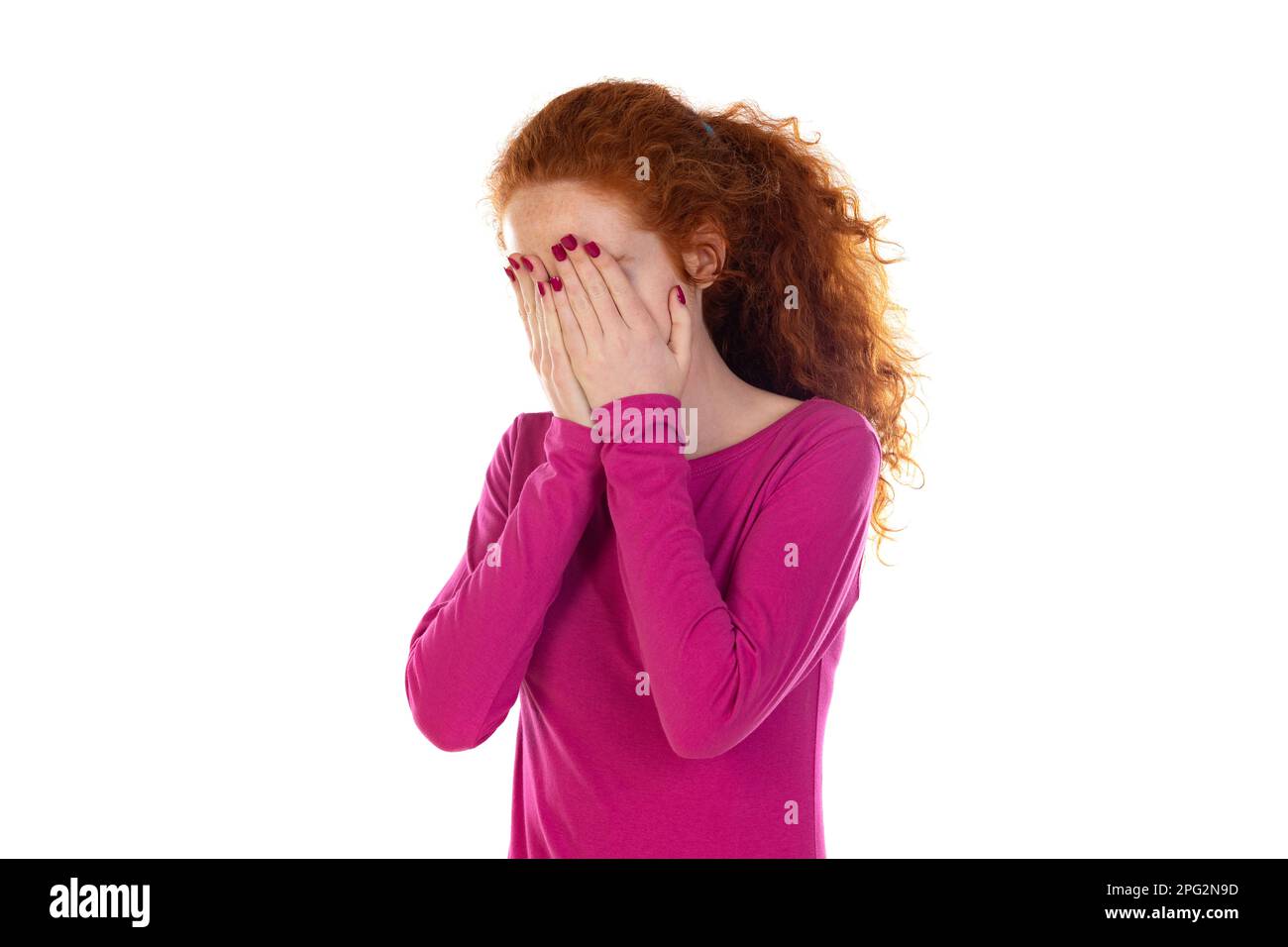 Beautiful fragile redheaded young woman in the dark. Sad frightened ...