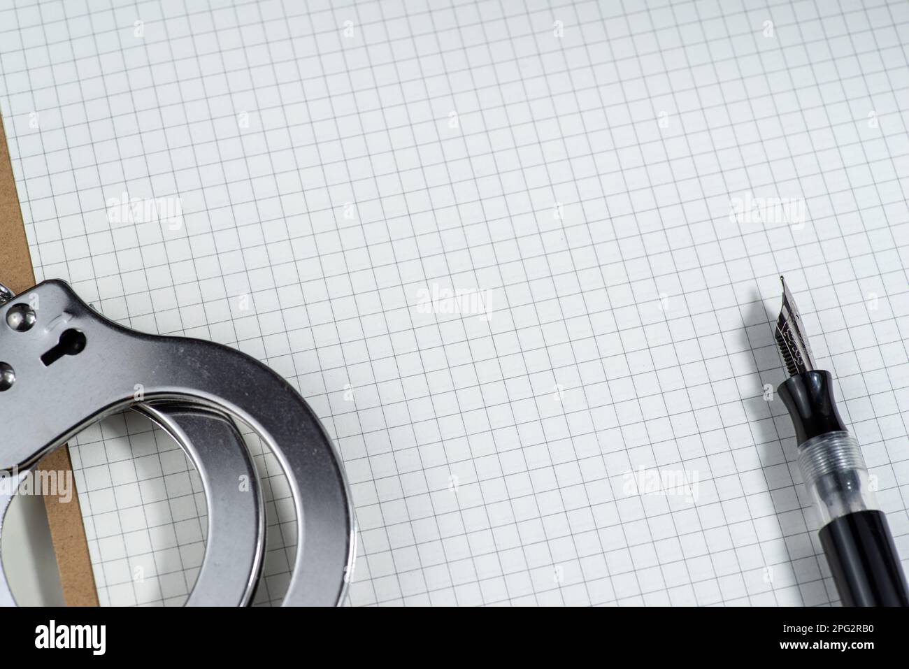 Slide calipers and handcuffs on a graph paper,copy space Stock Photo ...