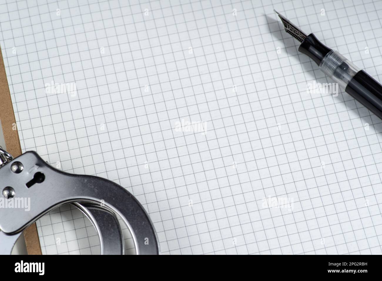 Slide calipers and handcuffs on a graph paper,copy space Stock Photo ...