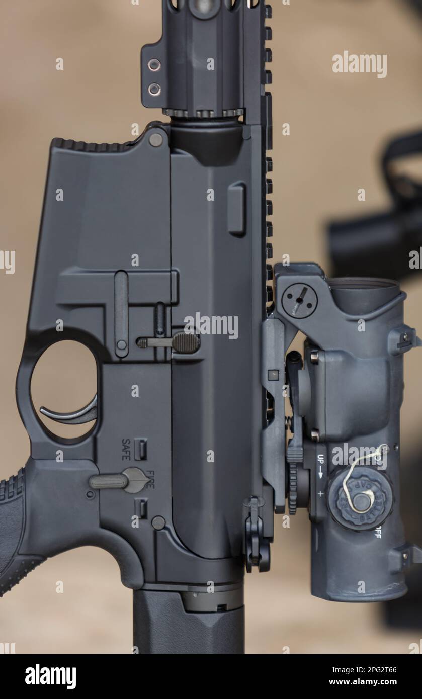 Modern black assault rifle with mounted magnifier scope. Standard ...