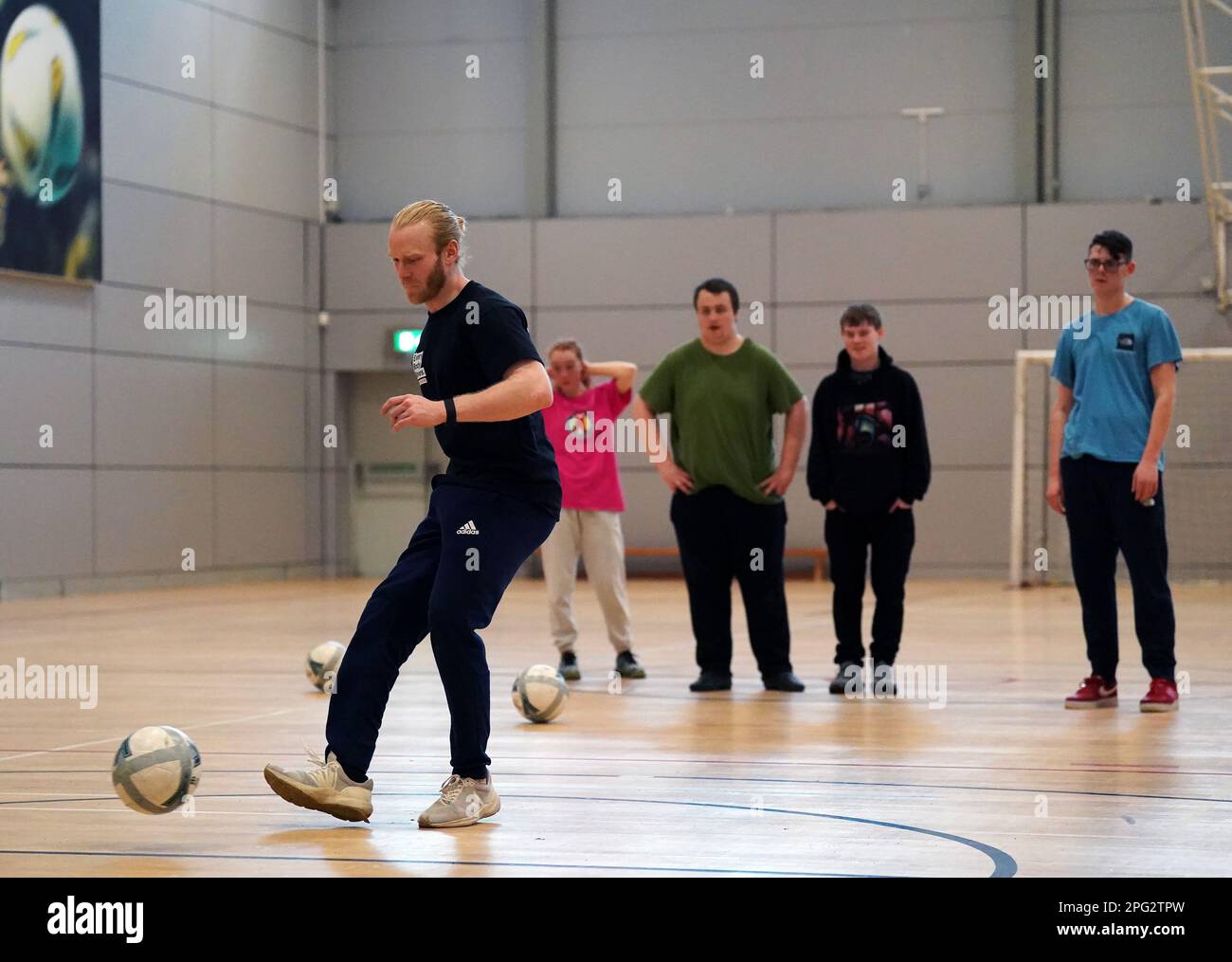 Paralympic gold medallist Jonnie Peacock kicking a ball in an inclusive ...