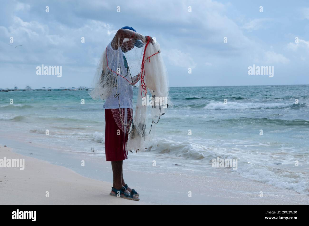 Fishing as a way of life: fisherman casting his net on the beach Stock ...