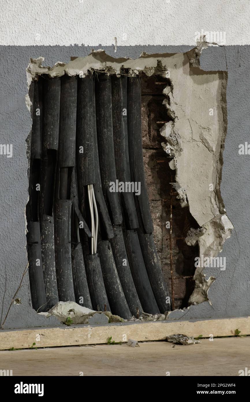 Old electrical wires in damaged plastic insulation, in mounting hole in ...