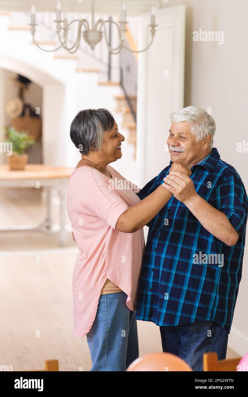 Happy diverse senior people holding hands and dancing at home Stock ...