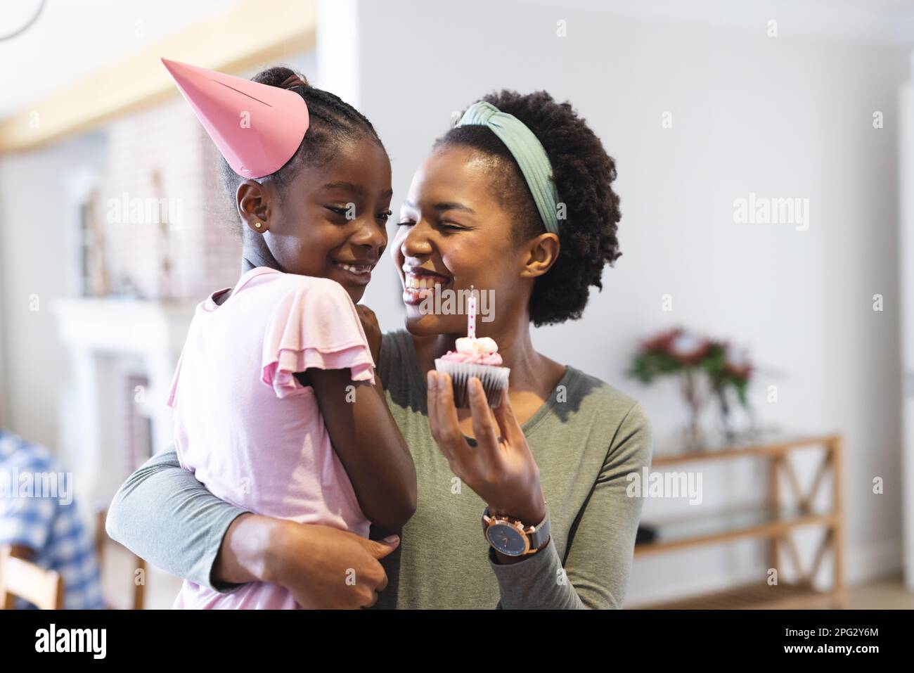 Happy african american mother and daughter celebrating birthday ...