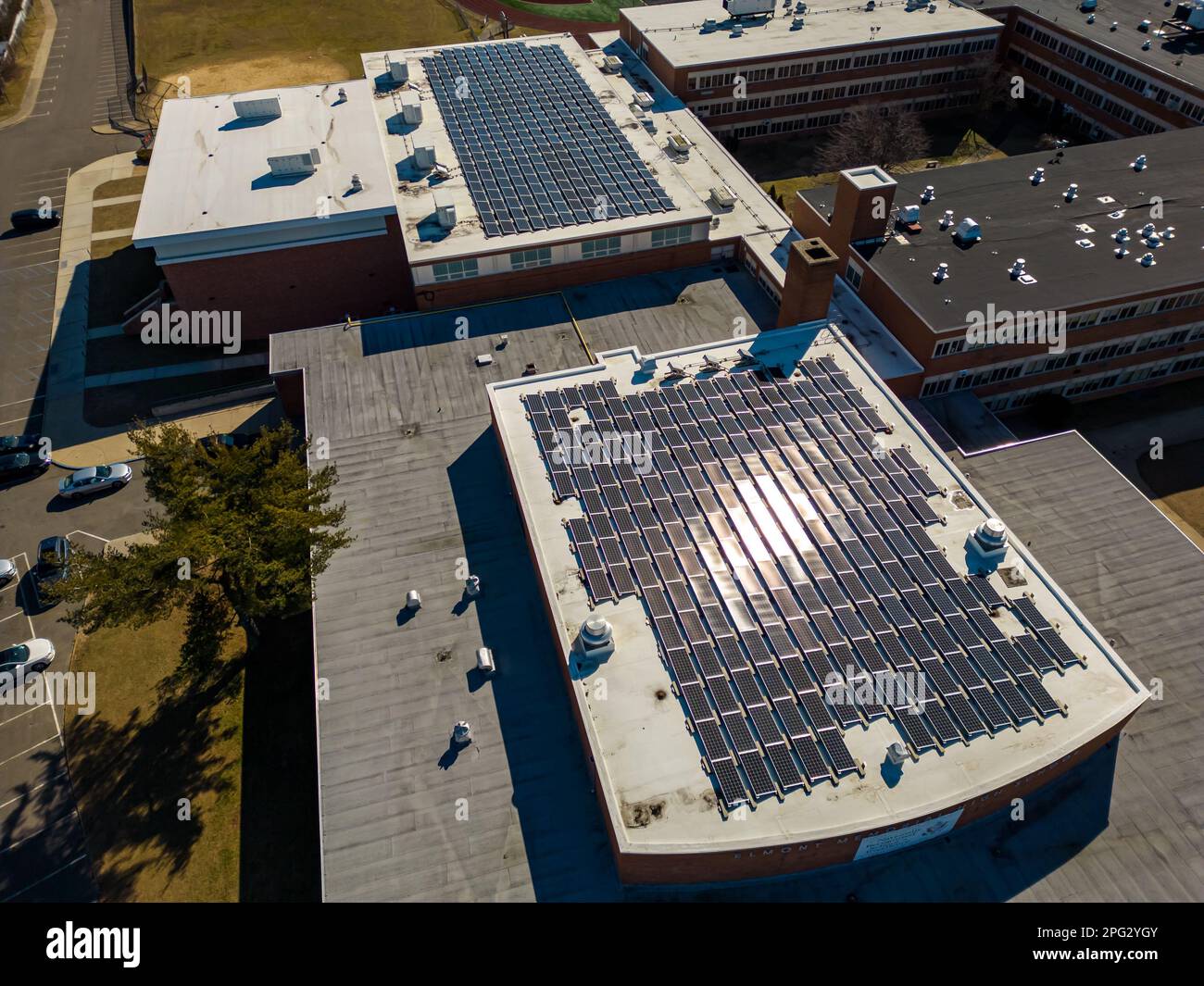 An aerial view of a school with solar panels on the roof in Long Island ...