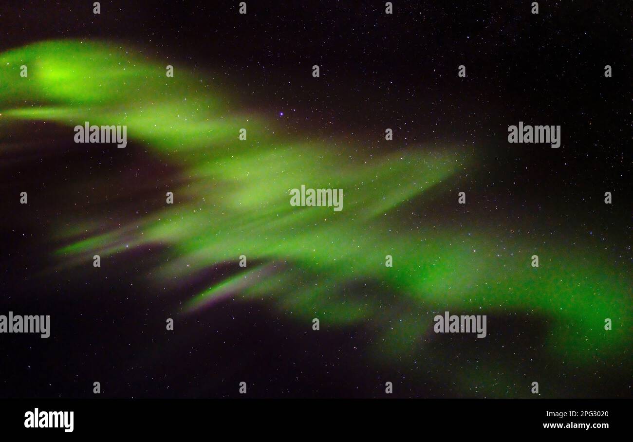 Northern Lights over the town. Town Tasiilaq (formerly called Ammassalik), the biggest town in ...