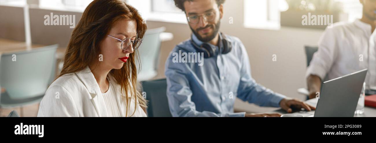 Group of young diverse coworkers analyzing sales report while working ...