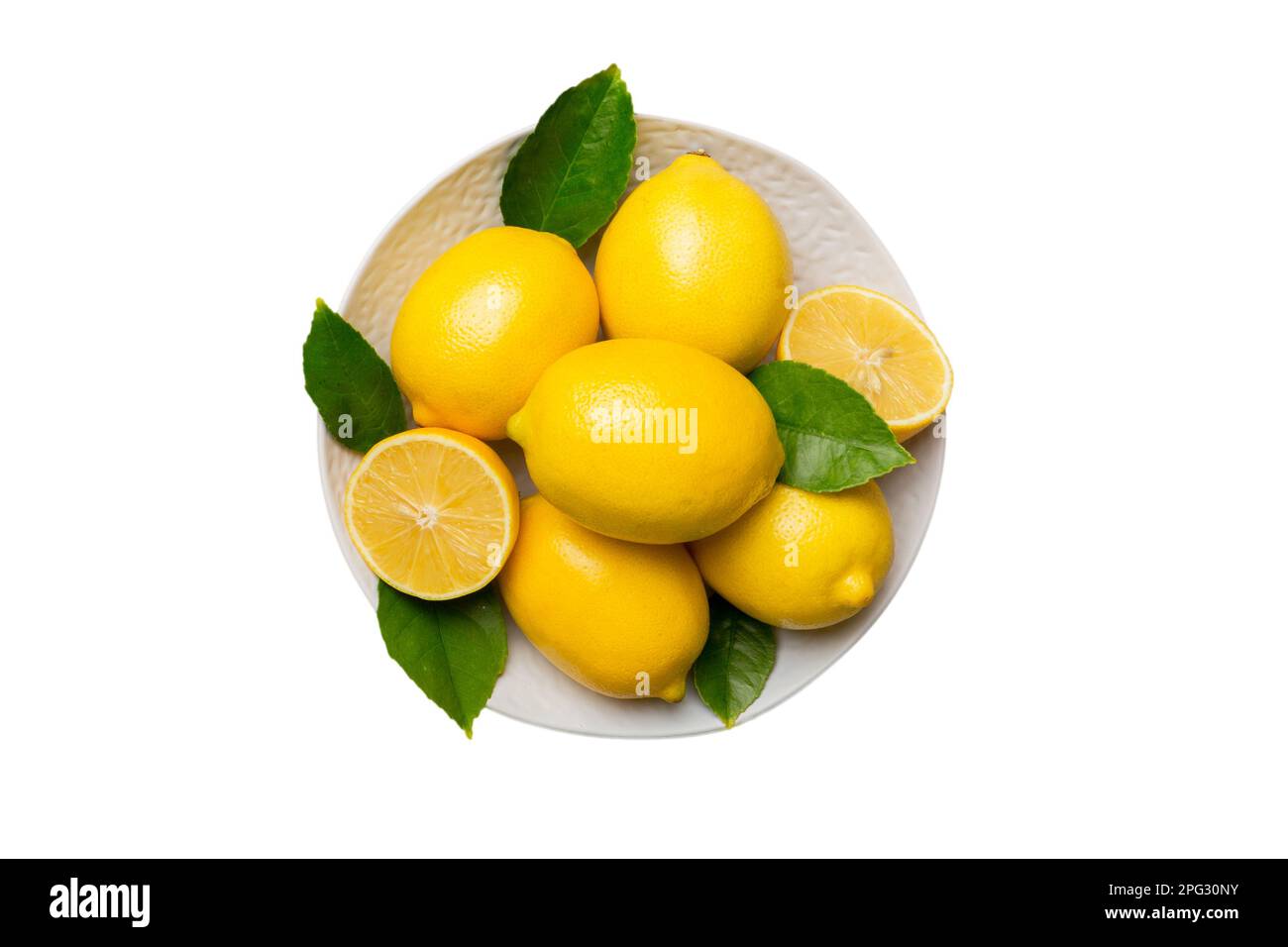 Fresh cutted lemon and whole lemons over round plate isolated on white ...