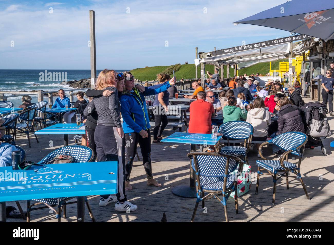 People enjoying a relaxing time on the outdoor decking area of the ...