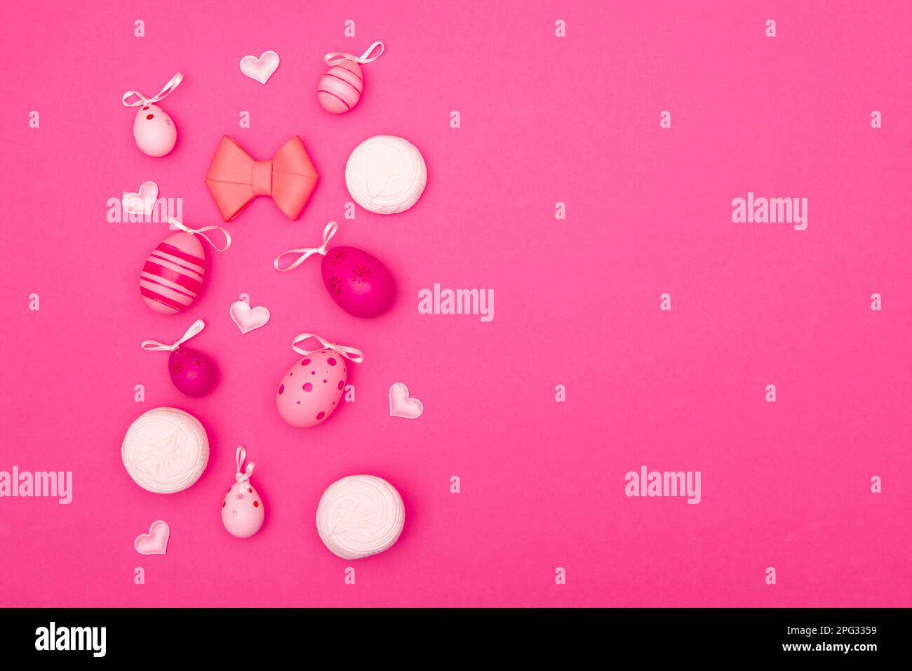 Easter background in pink with eggs, hearts, marshmallows and bow makes ...