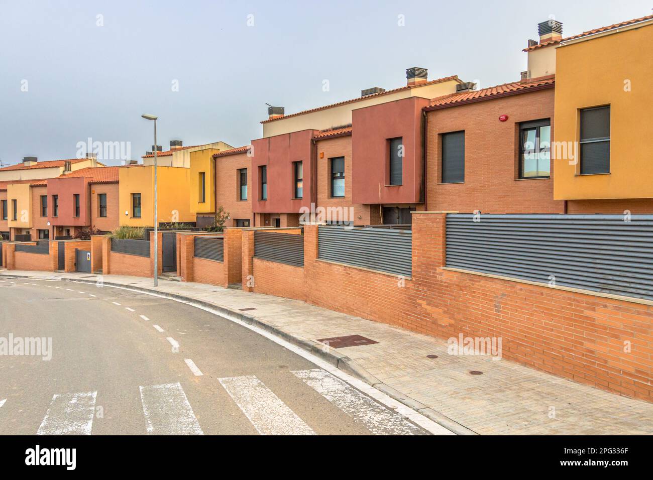 Modern row houses in Terra earth colors in Spain Stock Photo - Alamy