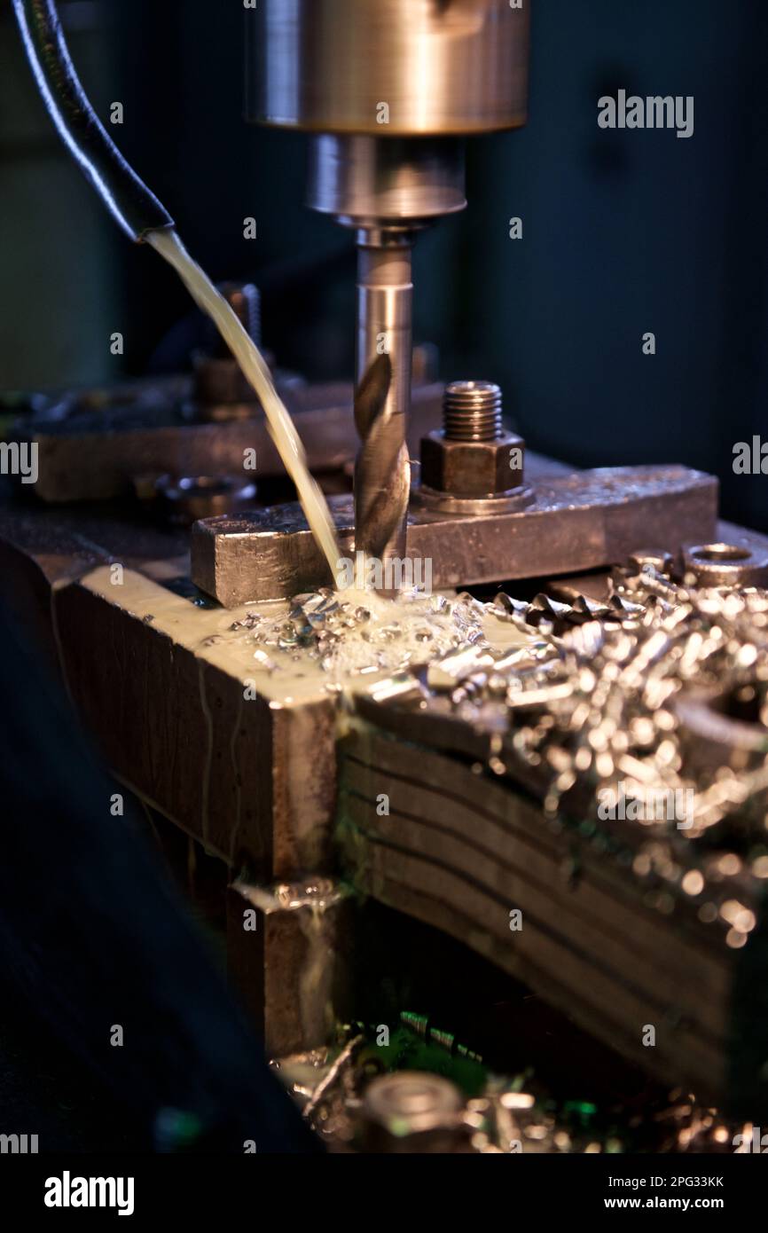 the work of a drill on a metal workpiece at the factory Stock Photo - Alamy