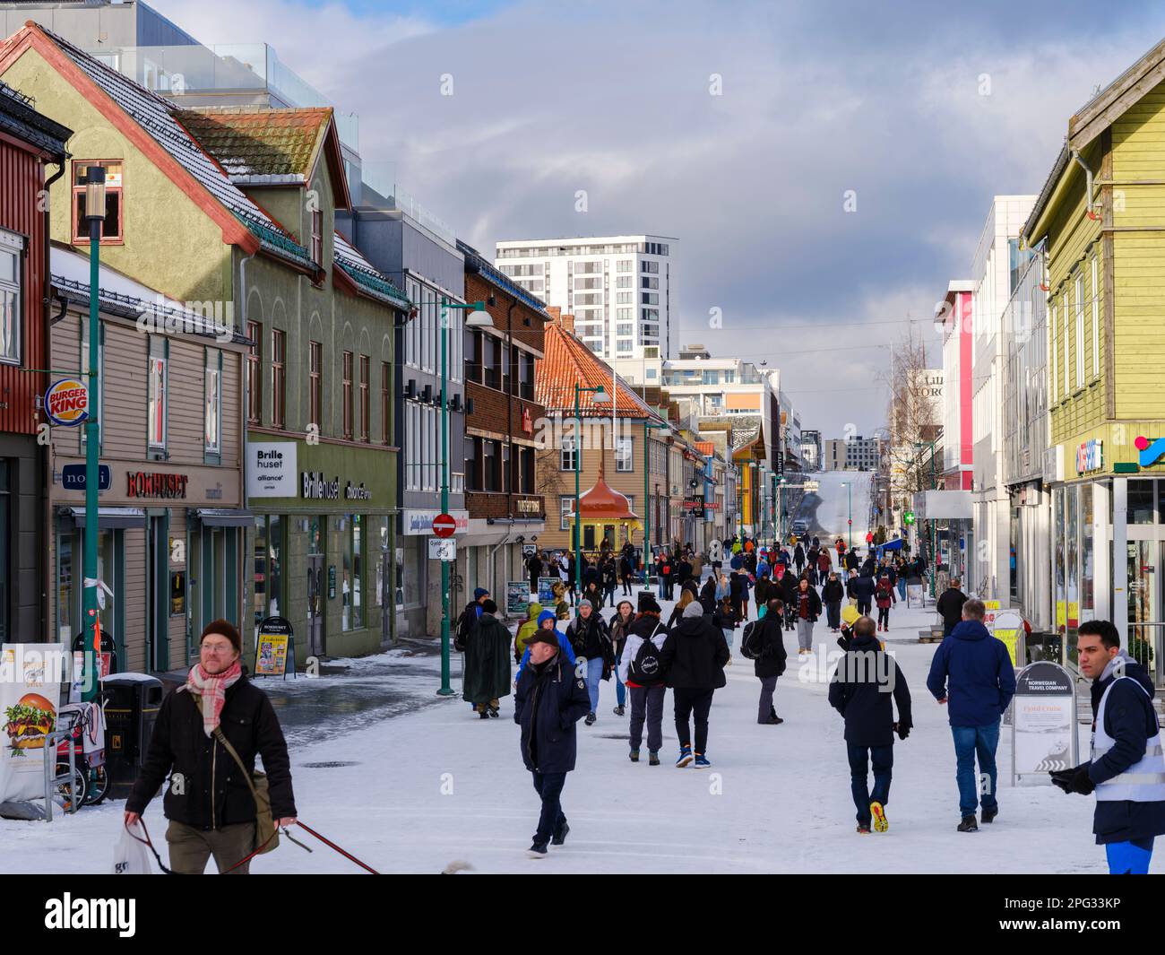 Visitors on steet Storgata. Tromso or Tromsoe during winter in the ...