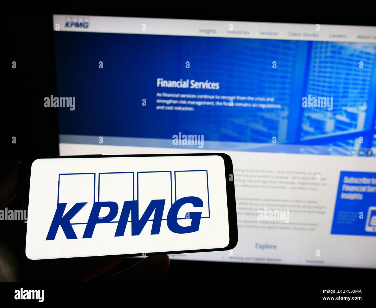 Person holding smartphone with logo of professional services company ...